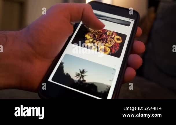 Man using smartphone scrolling through social network feed, doing swiping, scrolling gestures ...