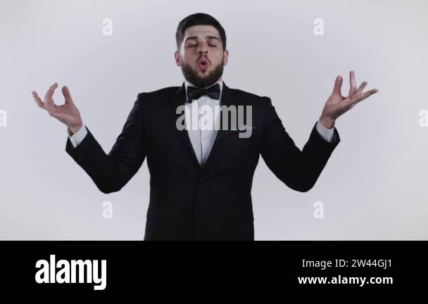 Calm man in black tuxedo relaxing, meditating. Gentleman calms down ...