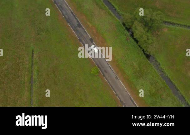 Top Down Overhead Aerial View of Electric Vehicle driving trough Nature ...