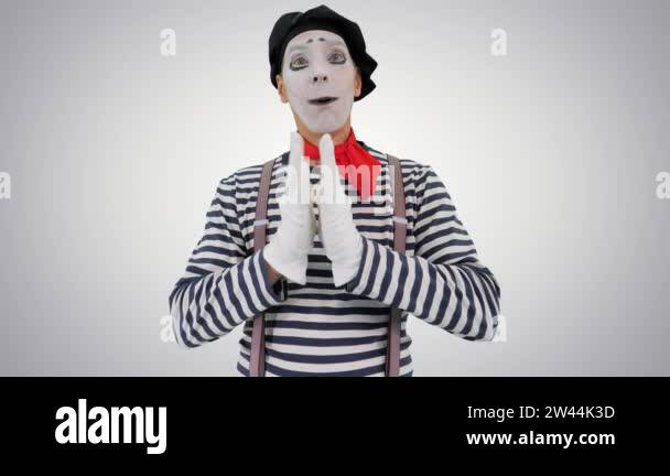 Mime holding touching imaginary wall and making imaginary bird on ...