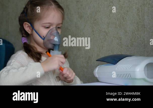 Little girl makes an inhalation vapor and draws a drawing. Child is ...