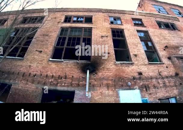 Soviet factory building with large broken windows. Soviet brick factory ...