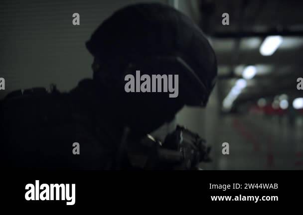 Special forces team hiding behind wall with assault rifles during ...