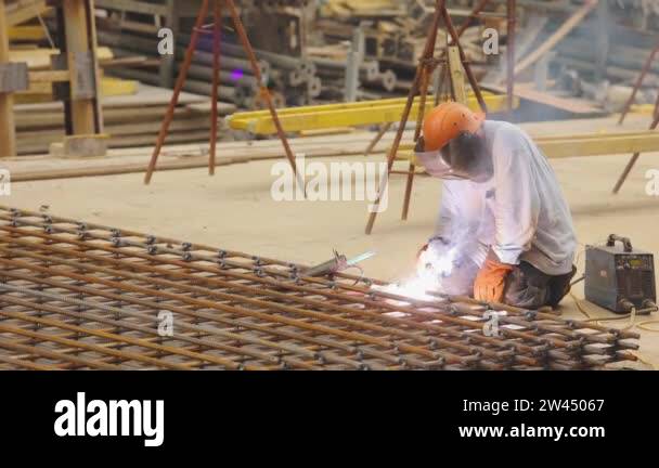 A welder welds a metal structure. Welding metal construction ...