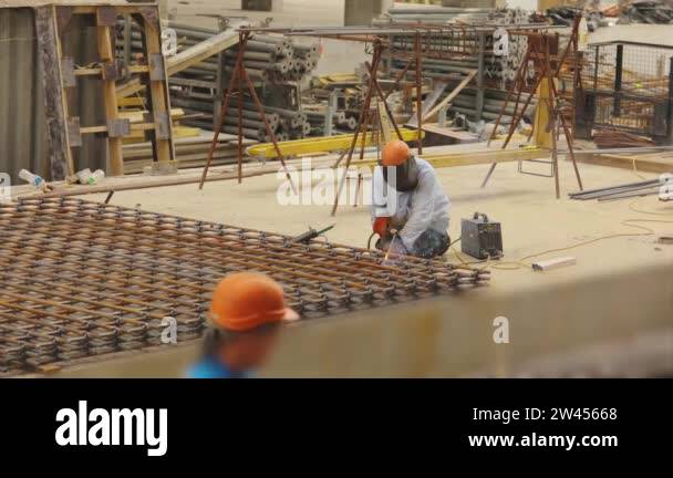 A welder welds a metal structure. Welding metal construction ...