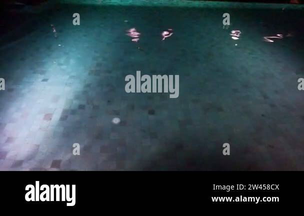 Lighting and water running in a dark swimming pool at night Stock Video ...