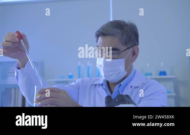 Research concept of 4k resolution. Scientists are dripping the compound ...