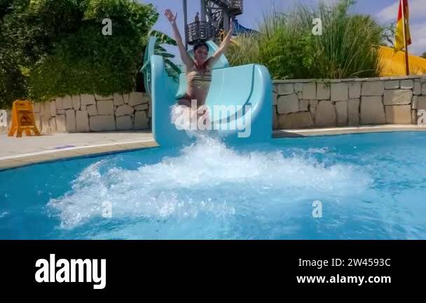 Descent from the waterslide on holiday aqua park. Slow motion on a ...