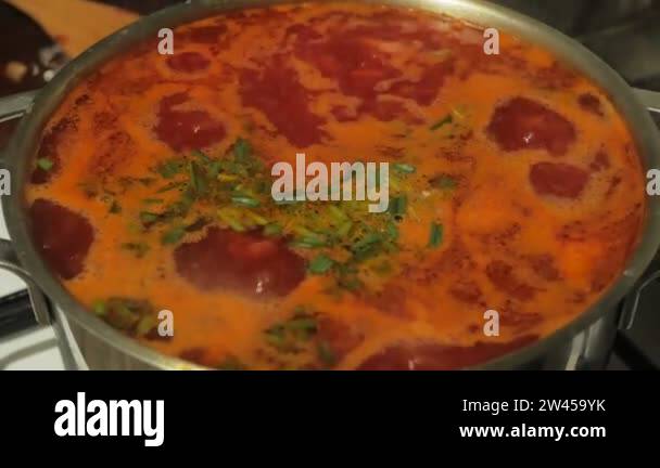 Real Ukrainian borscht is cooked in a saucepan. The chef prepares ...