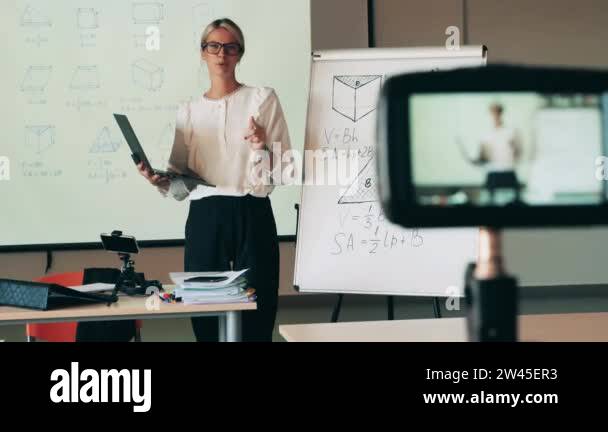 A woman is conducting a geometry lesson while being filmed online ...