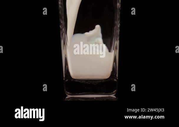 Drink milk. Super slow motion shot of pouring fresh milk into a ...