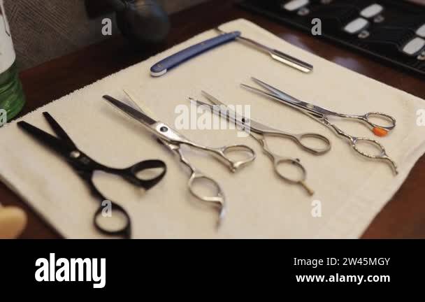 Barber shave razor. Barber preparing straight razor for shaving client ...