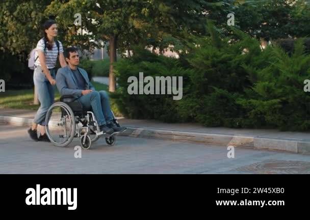 Woman pushing a man in a wheelchair Stock Videos & Footage - HD and 4K ...