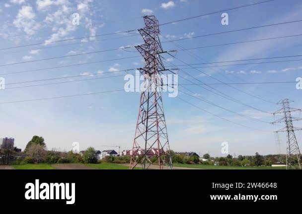 Power pylons and high voltage lines in an agricultural landscape. High ...