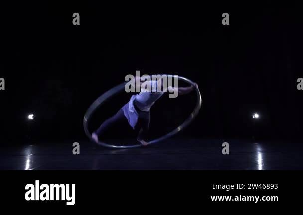 Circus artist shows concentration and balance while spinning on a Cyr ...