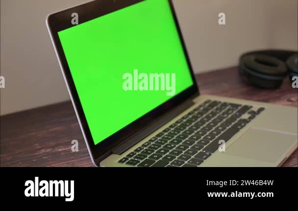 4K Green Screen Of Laptop Computer Set On Working Space, Pan Shot Stock ...