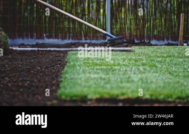 Gardener Grading Out Soil With A Rake. SLOW MOTION. Unrecognizable ...