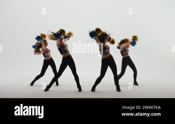 Group of athletic cheerleaders in silver tops and black tight leggings ...