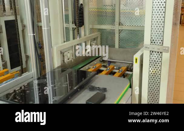 The computer case moves along a conveyor belt and is loaded into an ...