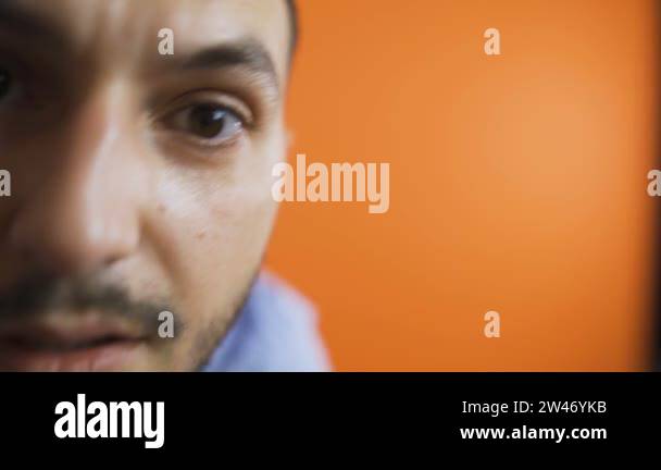 Man cleaning his camera lens, seen through the camera. Close up, door ...