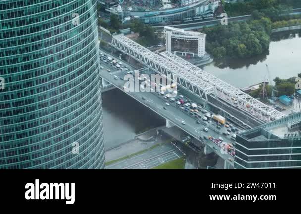 Top view of high-rise and traffic on bridge. Action. View from high ...