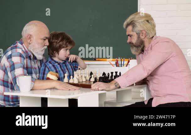 Grandfather Father and grandson playing chess at home. Games and ...