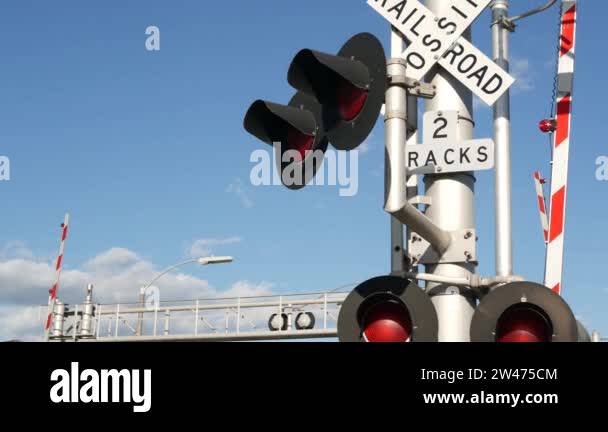 Level crossing warning signal in USA. Crossbuck notice and red traffic ...