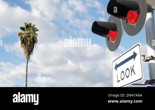 Level crossing warning signal in USA. Crossbuck notice and red traffic ...