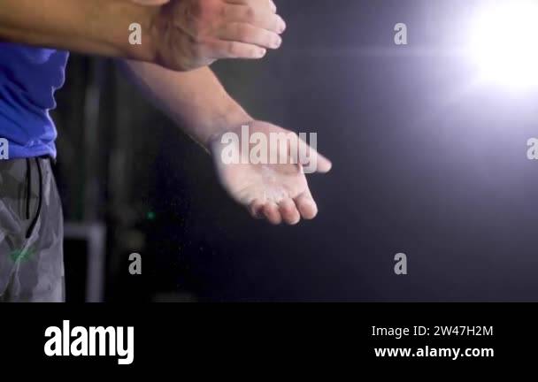 Sportsman hands gym chalk covering hands. Bodybuilder clap magnesium ...