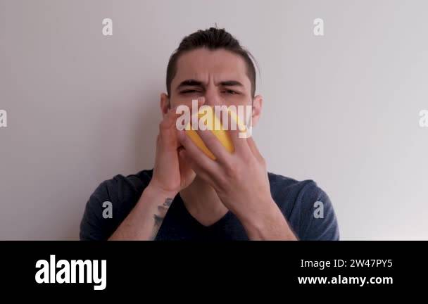 Inflate a yellow balloon with mouth and then let it fly away. Young ...