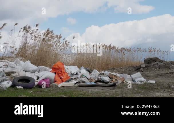 garbage dump near the river. Ecological Problem. Illegal construction ...