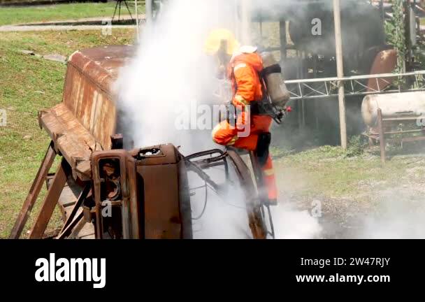 Firefighter fighting with fire flame protection property. Fireman wear ...
