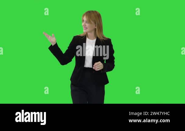 Female presenter blond woman walking and pointing to the sides on a ...