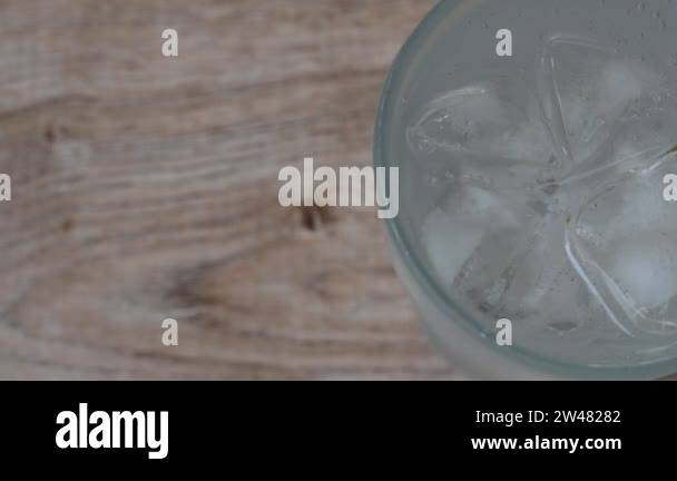 soda carbonate water with bubble floating in drinking glass on rable ...