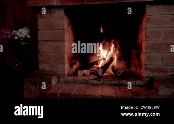 The fire in the fireplace gives warmth and comfort, casting a dim light ...