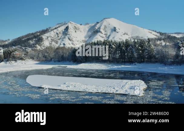 Melting ice on a freshwater river lake. A frozen field of snow and ice ...