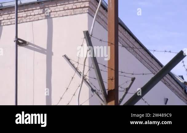 prison barbed wire around lantern pole. jail, restricted area ...