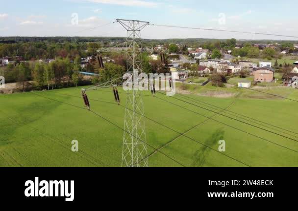 Power pylons and high voltage lines in an agricultural landscape. High ...