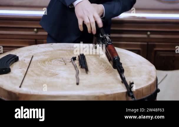 Process of assembly of the Kalashnikov rifle. Video. Close up of man ...