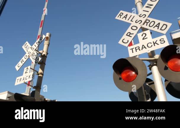 Level crossing warning signal in USA. Crossbuck notice and red traffic ...