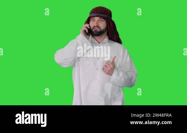 Arab sheikh making a call walking on a Green Screen, Chroma Key Stock ...