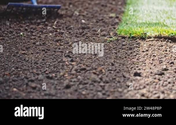 Gardener Grading Out Soil With A Rake. SLOW MOTION. Unrecognizable ...