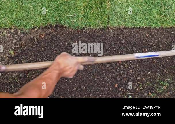 Gardener Grading Out Soil With A Rake. SLOW MOTION. Unrecognizable ...