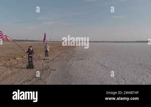 Two men on gyroboards with flags of the United States and Great Britain ...