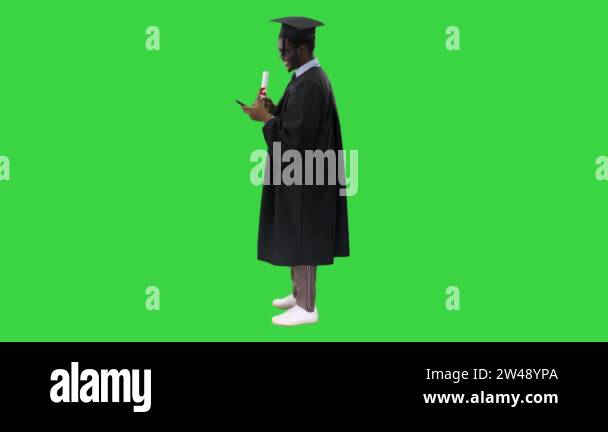 Smiling african american male student in graduation robe with diploma ...