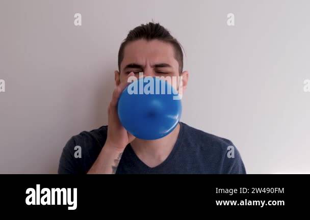 Inflate the blue balloon with mouth and then let it fly away. Young ...