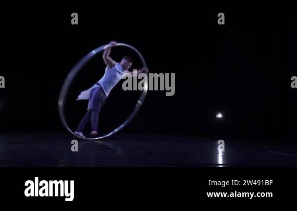 Circus artist shows concentration and balance while spinning on a Cyr ...