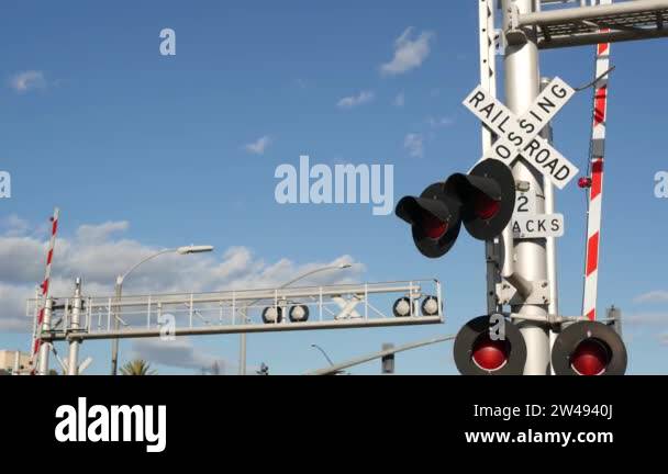 Level crossing warning signal in USA. Crossbuck notice and red traffic ...