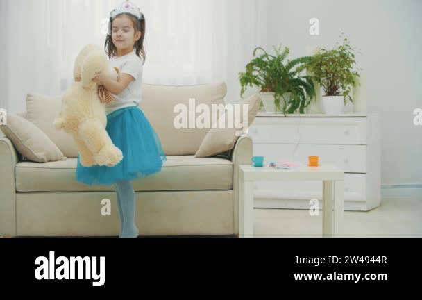 Little princess is dancing with her best friend teddy bear, turning ...