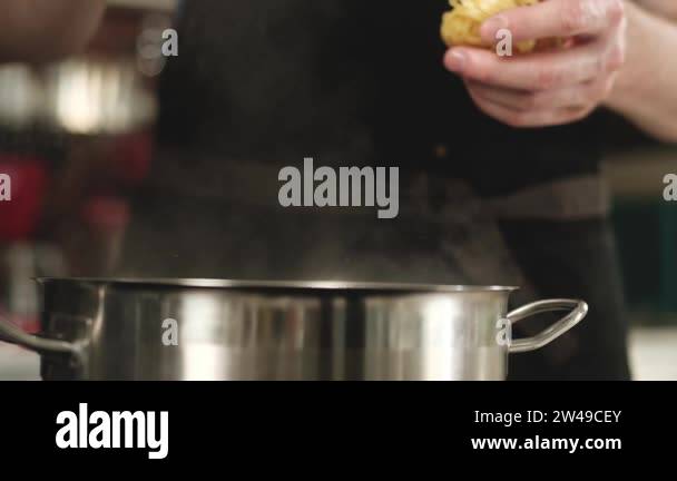 preparation of food in the kitchen at home. Spaghetti balls fall into ...